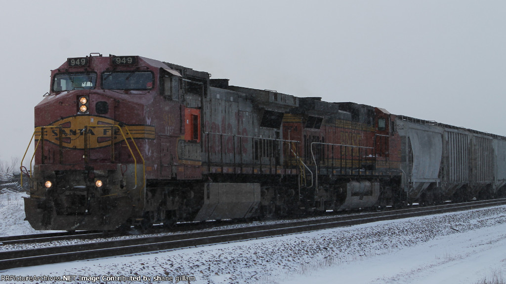 BNSF 949 leads the memgal into the siding for a meet in the snow.